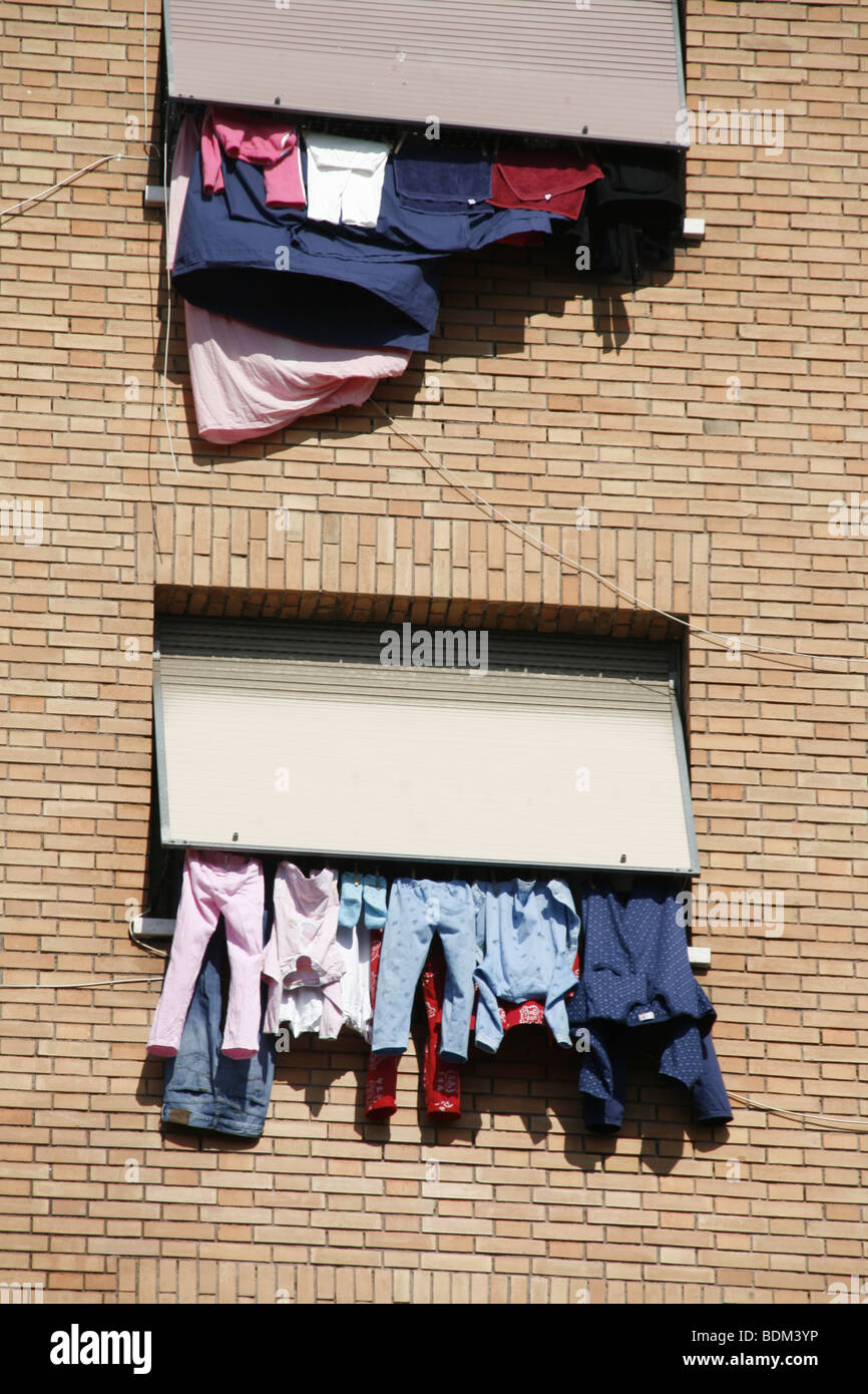 clothes on washing line by window in block of flats in italy Stock ...