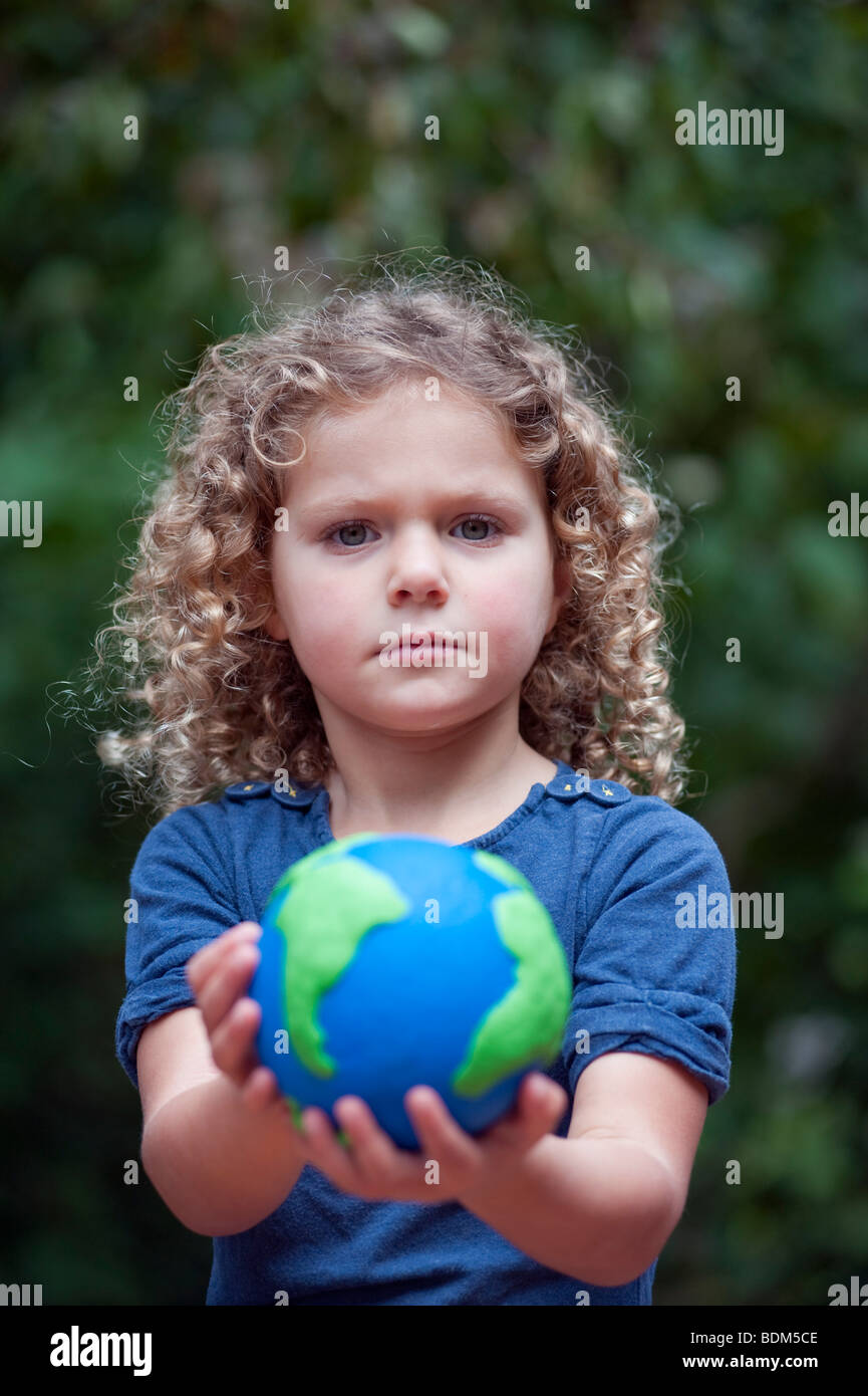 Young girl holding a model of planet Earth Stock Photo - Alamy