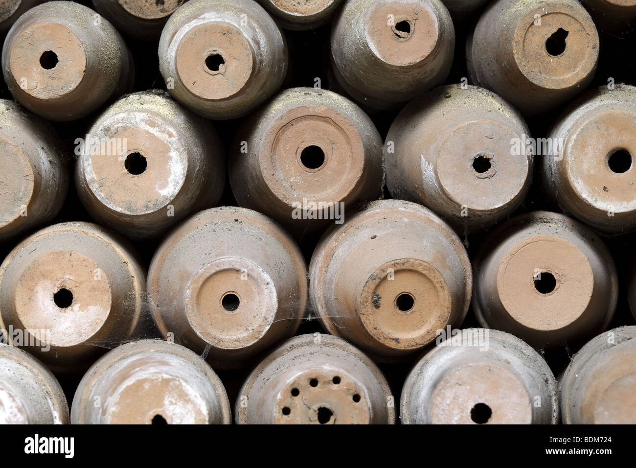 Flower pots stacked showing their bases Stock Photo - Alamy