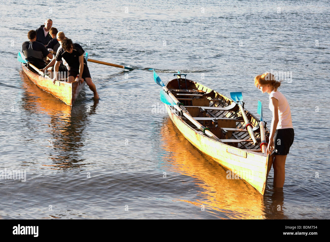 Young people in a rowing boat, part of a rowing club, Whitby Harbour ...