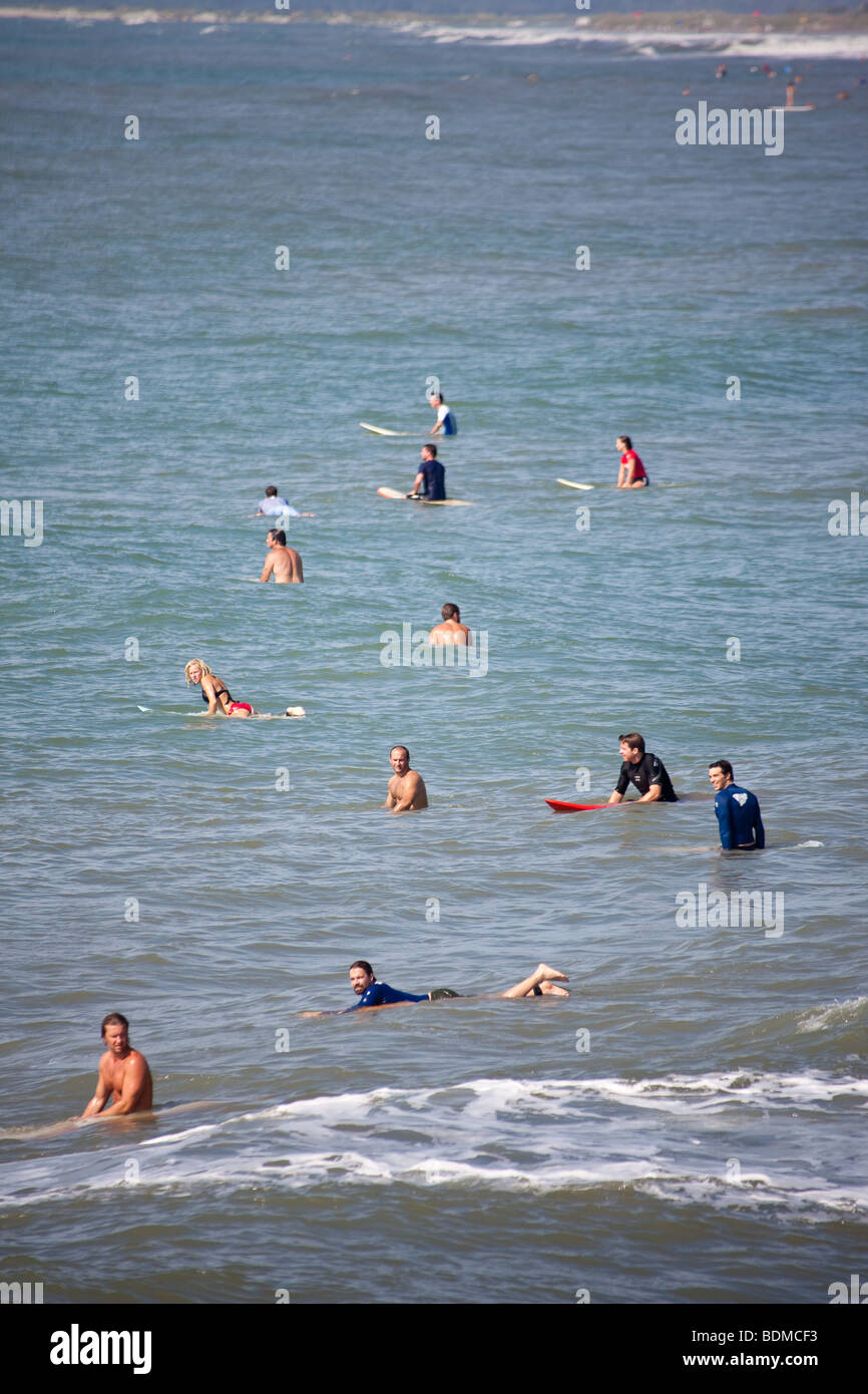 Surfers take advantage of the ocean swell generated by a passing ...