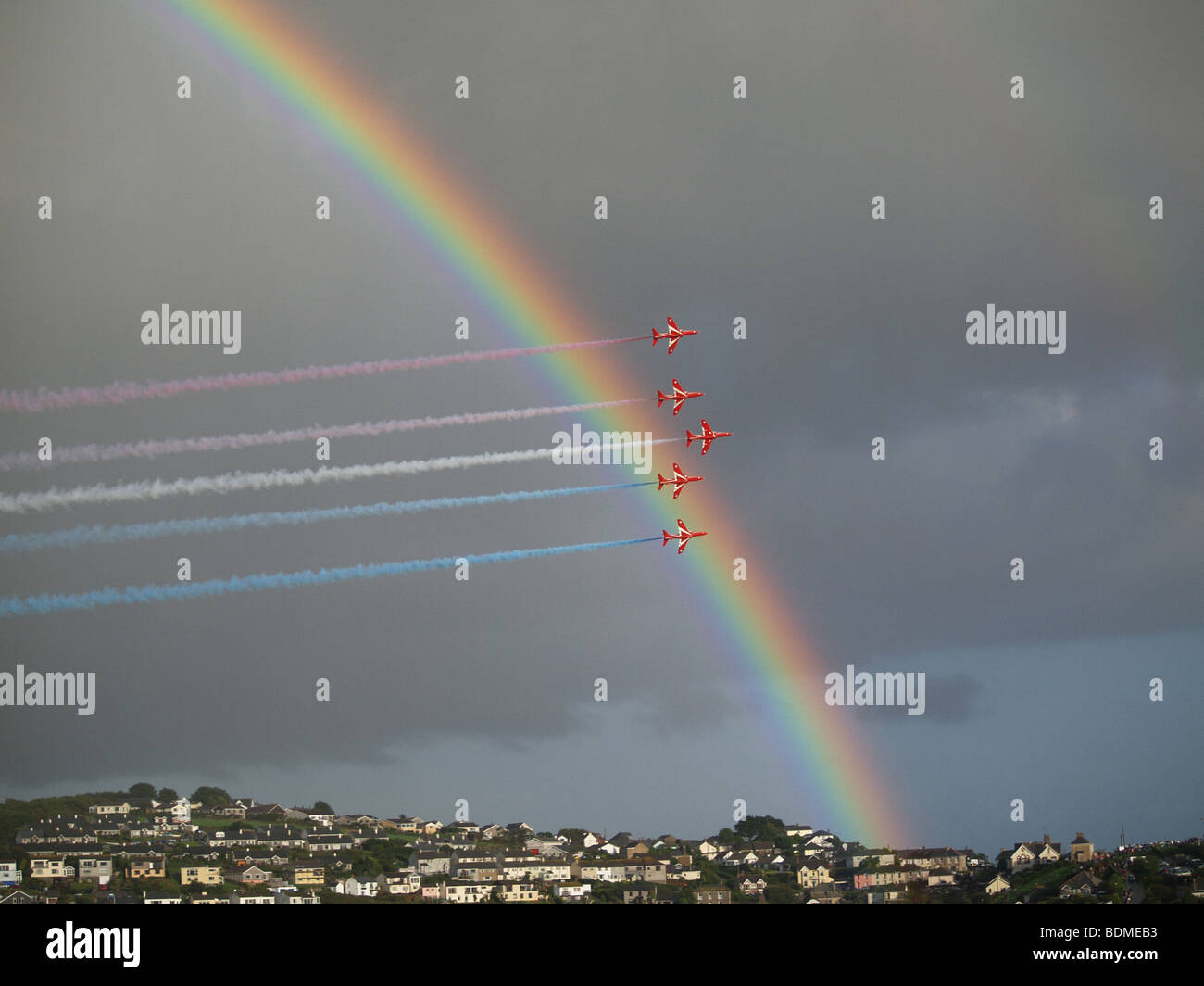 The Red Arrows fly in formation past a rainbow Stock Photo - Alamy