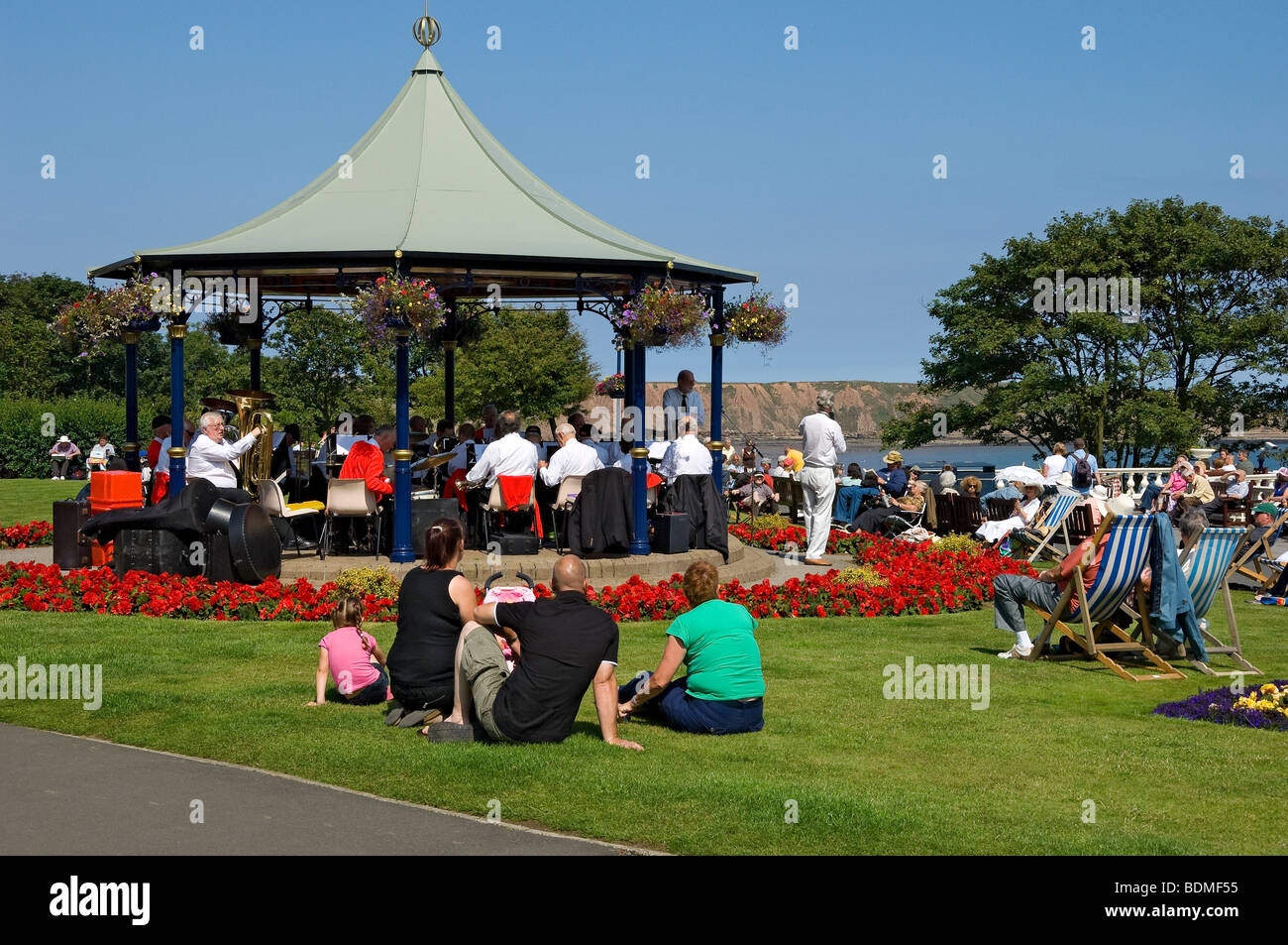 People tourists visitors at the bandstand in summer Crescent Gardens ...