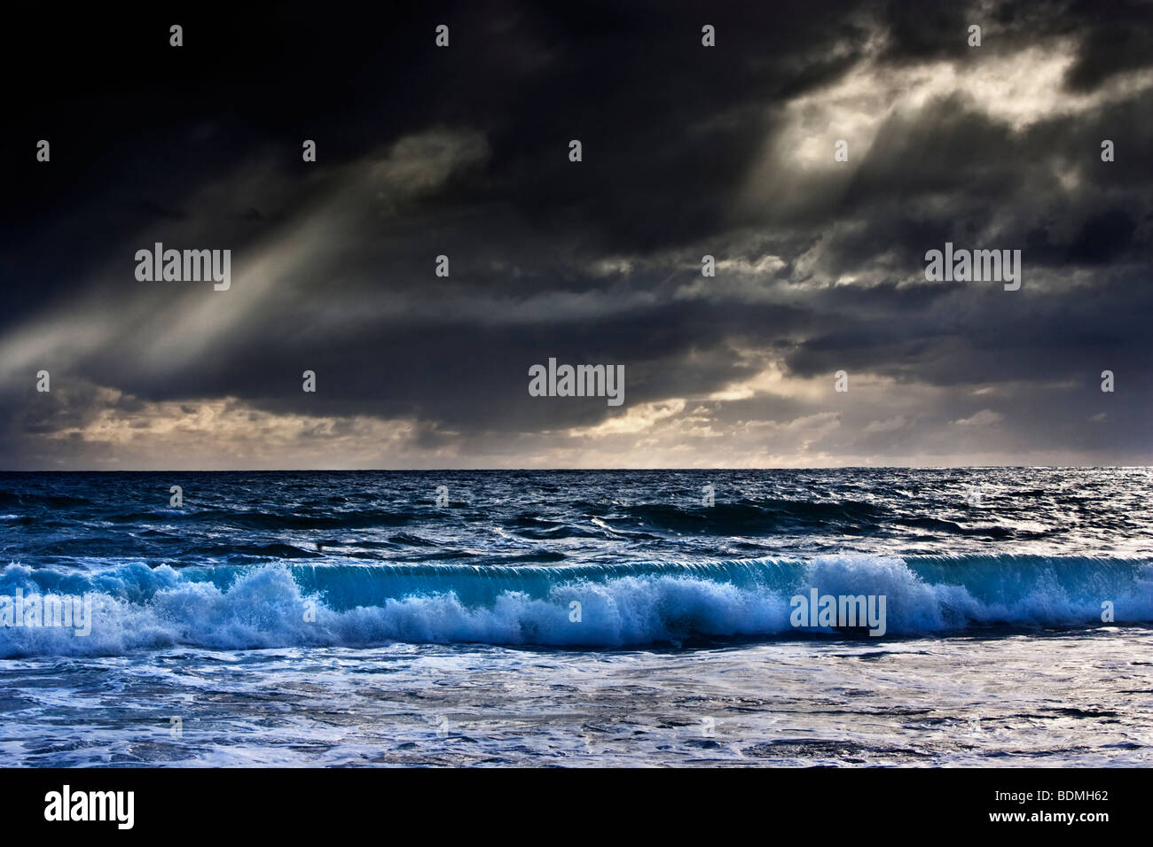Crepuscular rays and stormy skies over the ocean Stock Photo - Alamy