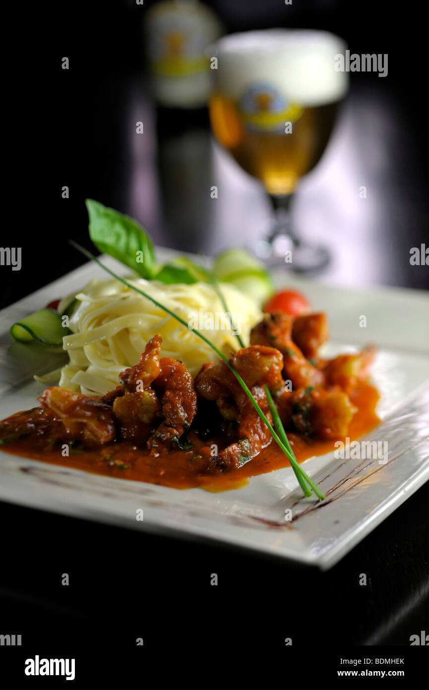 Stew with pasta and glass of beer Stock Photo - Alamy