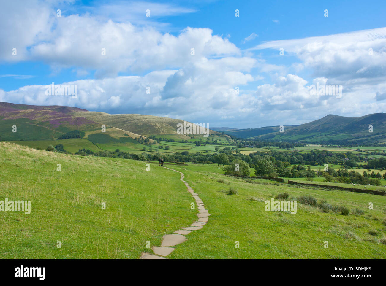 Two walkers on paved Pennine Way between Edale and Upper Booth, Peak ...