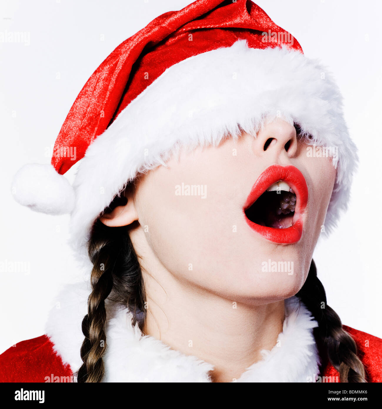 young funny and expressive woman dressed as santa claus is doing her ...