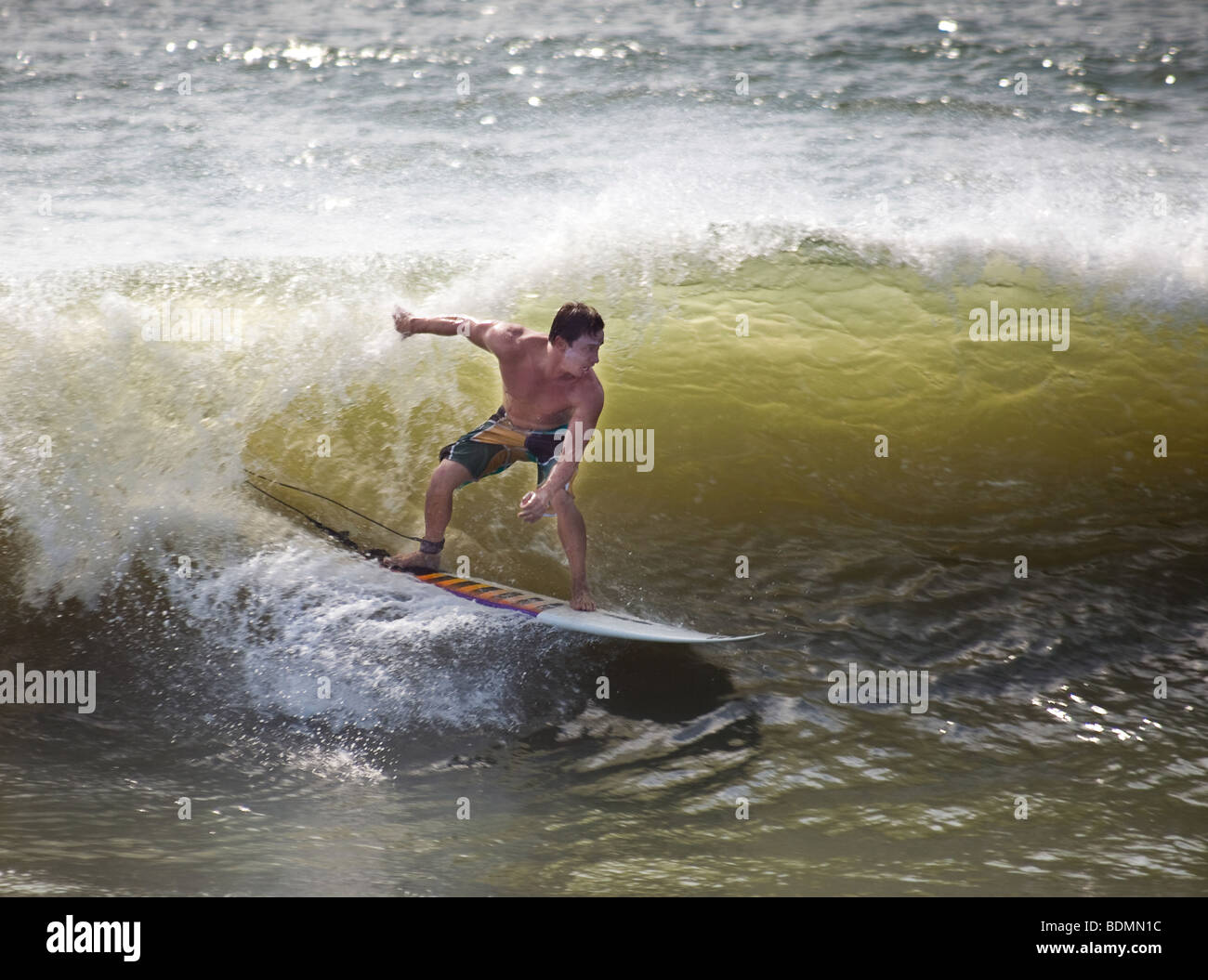 A surfer takes advantage of the ocean swell generated by a passing ...