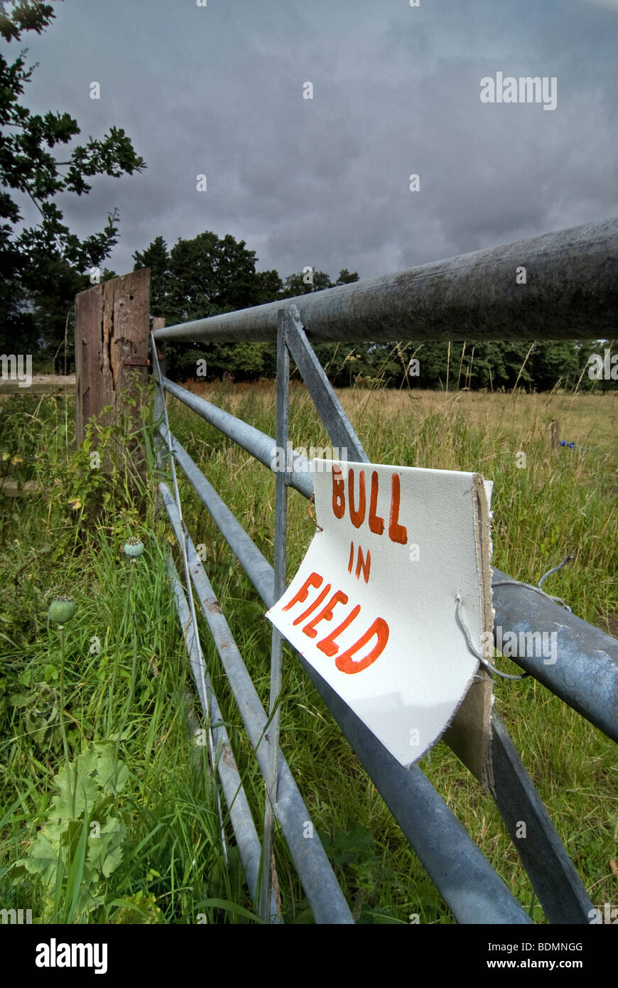warning sign on galvanised metal farm gate Stock Photo - Alamy