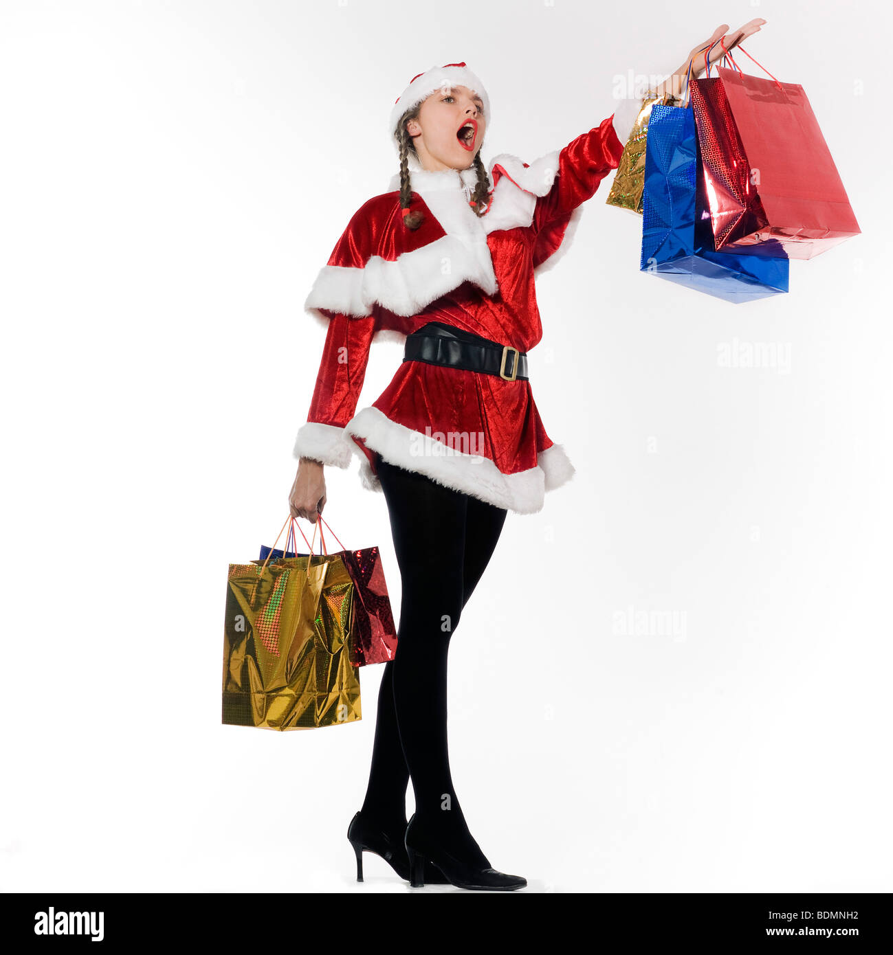 young funny and expressive woman dressed as santa claus is doing her ...