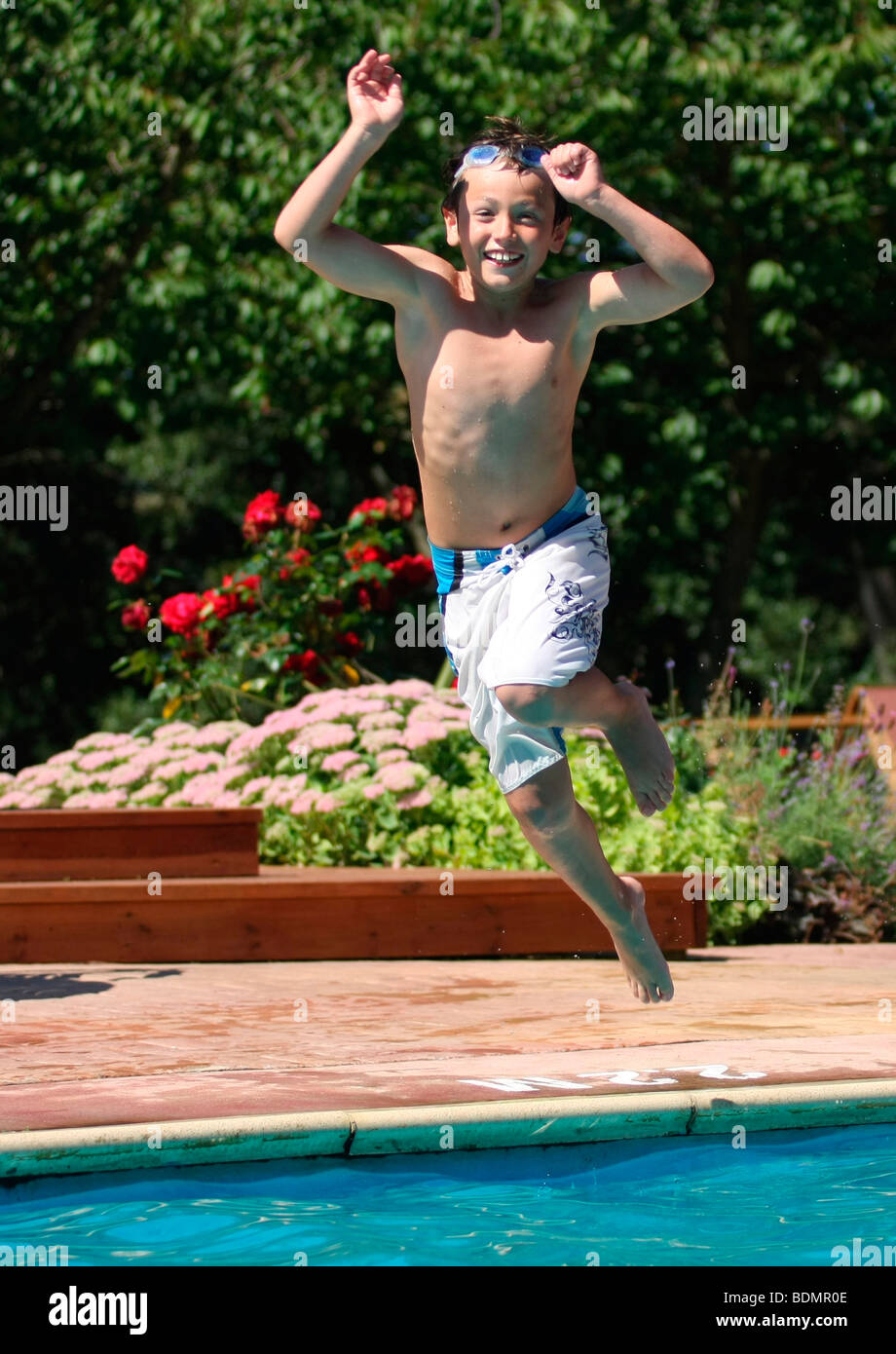 Boy jumping in swimming pool Stock Photo - Alamy
