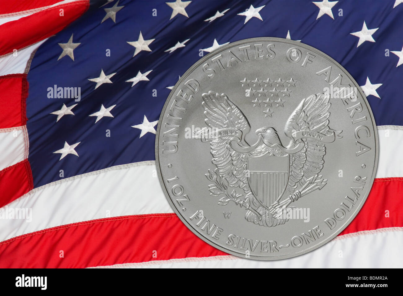 American Silver Eagle coin, with the United States flag waving in the ...