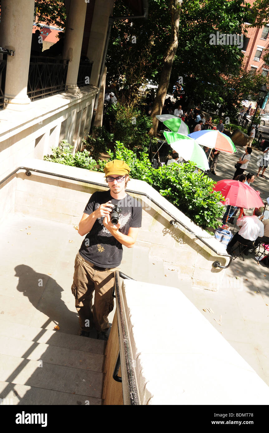 Guy with camera on stairs Stock Photo - Alamy