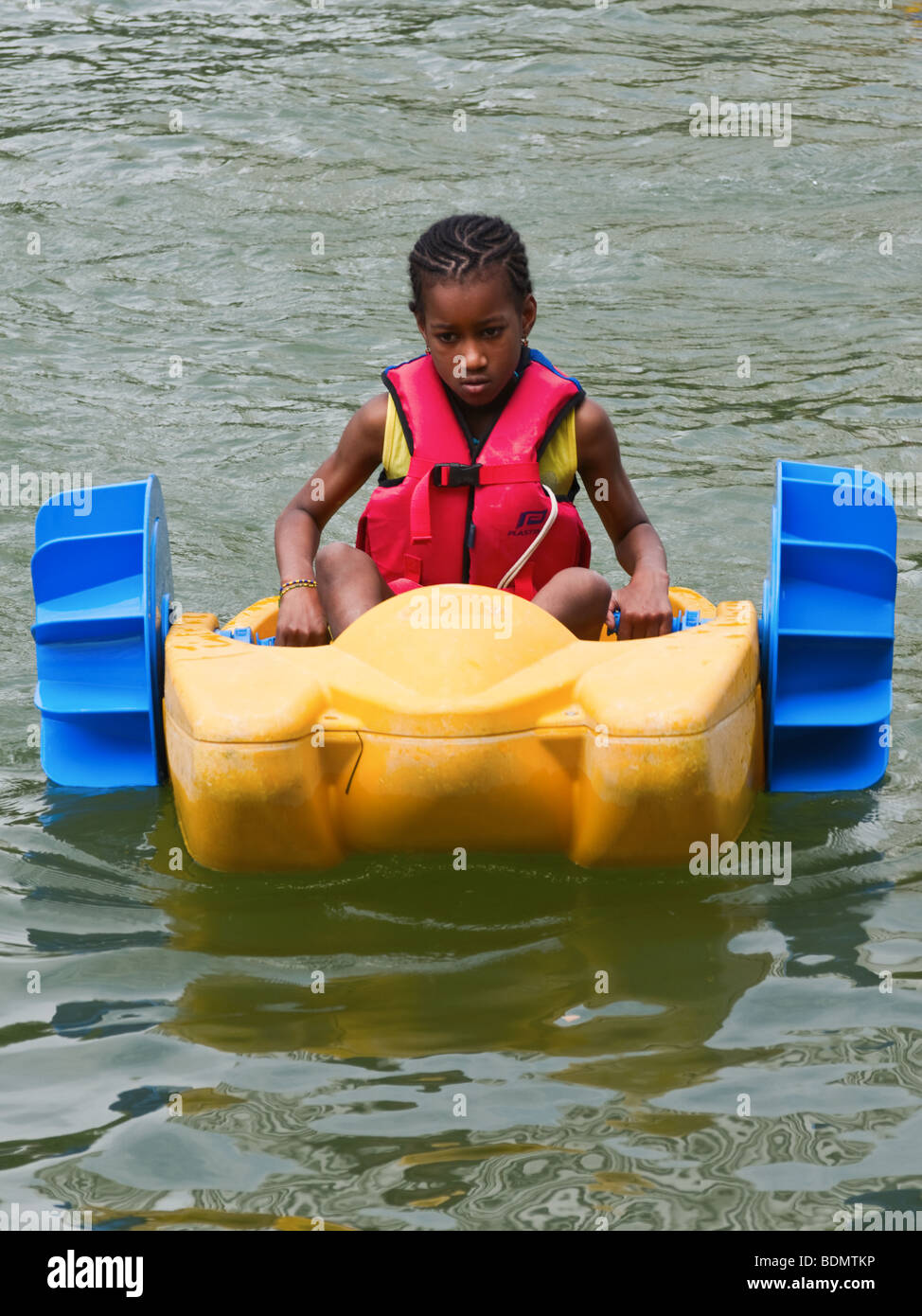 Child rowing a paddle boat View from the front. Close up Stock Photo ...