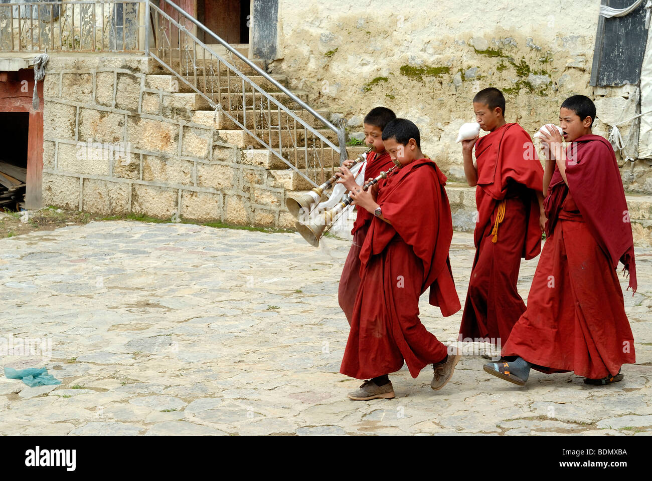 Monks starting a procession with conch shell horn and temple horns in ...