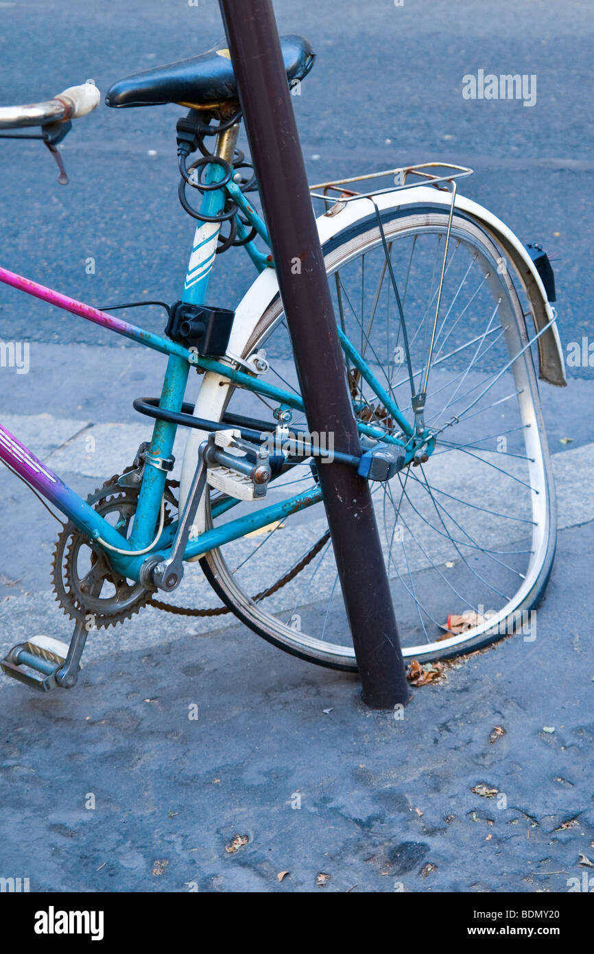 A cycle with a buckled wheel and chain off View from the side. Close up ...