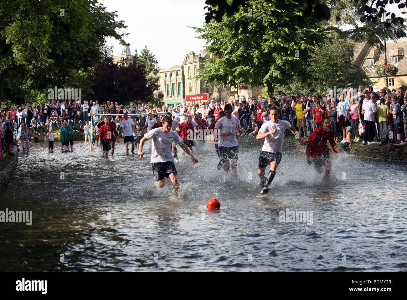 The annual football match held in The River Windrush Bourton on the ...