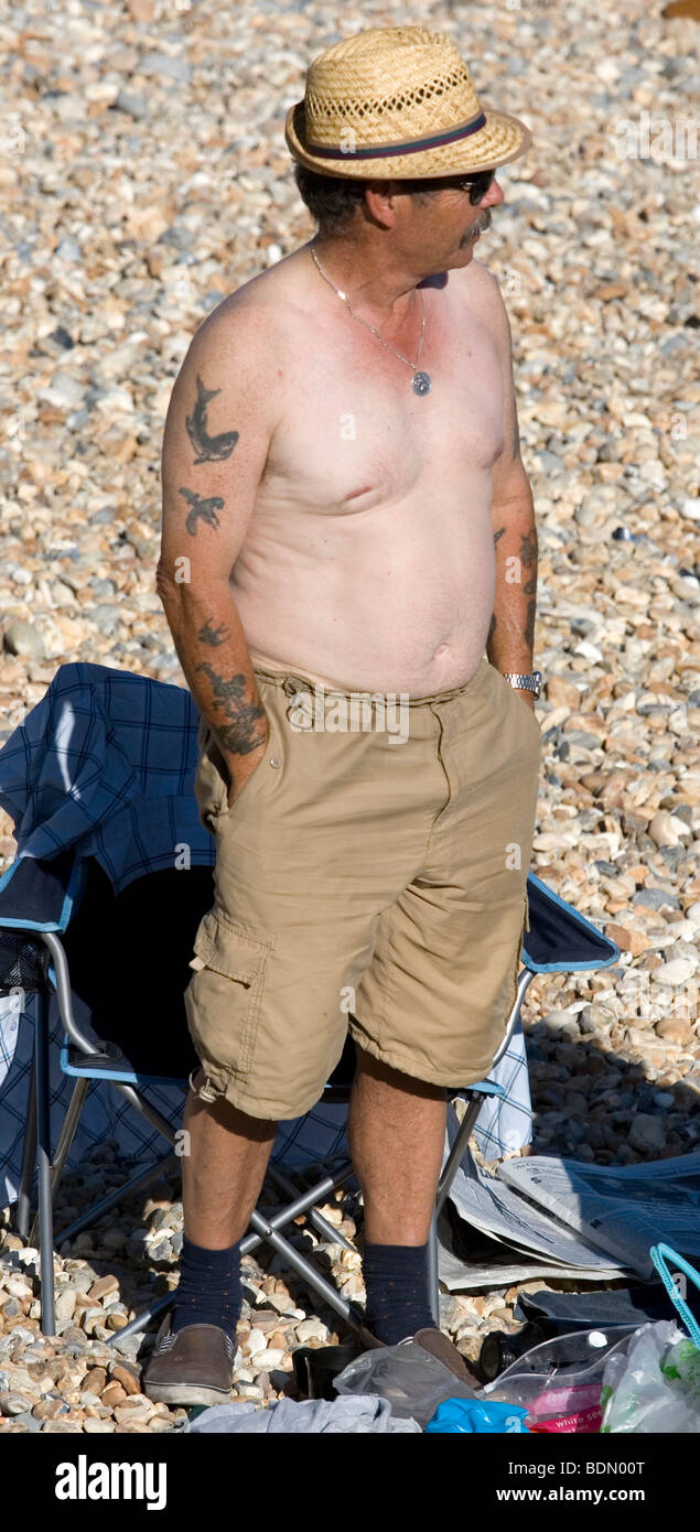 A pale man on the beach at Eastbourne, England Stock Photo - Alamy