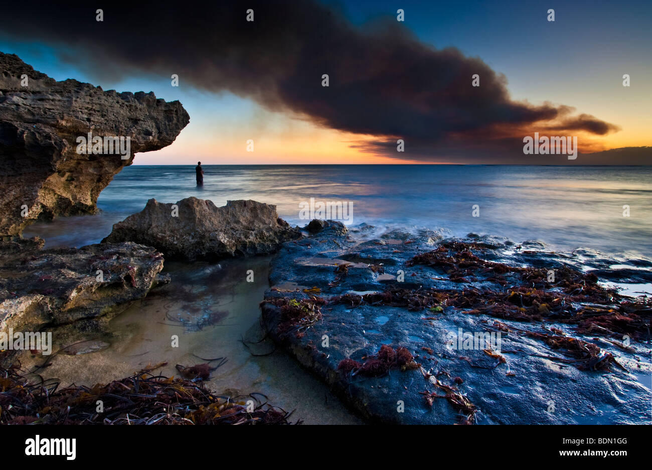 A man fishing on the coast at Point Peron, Perth, Western Australia ...