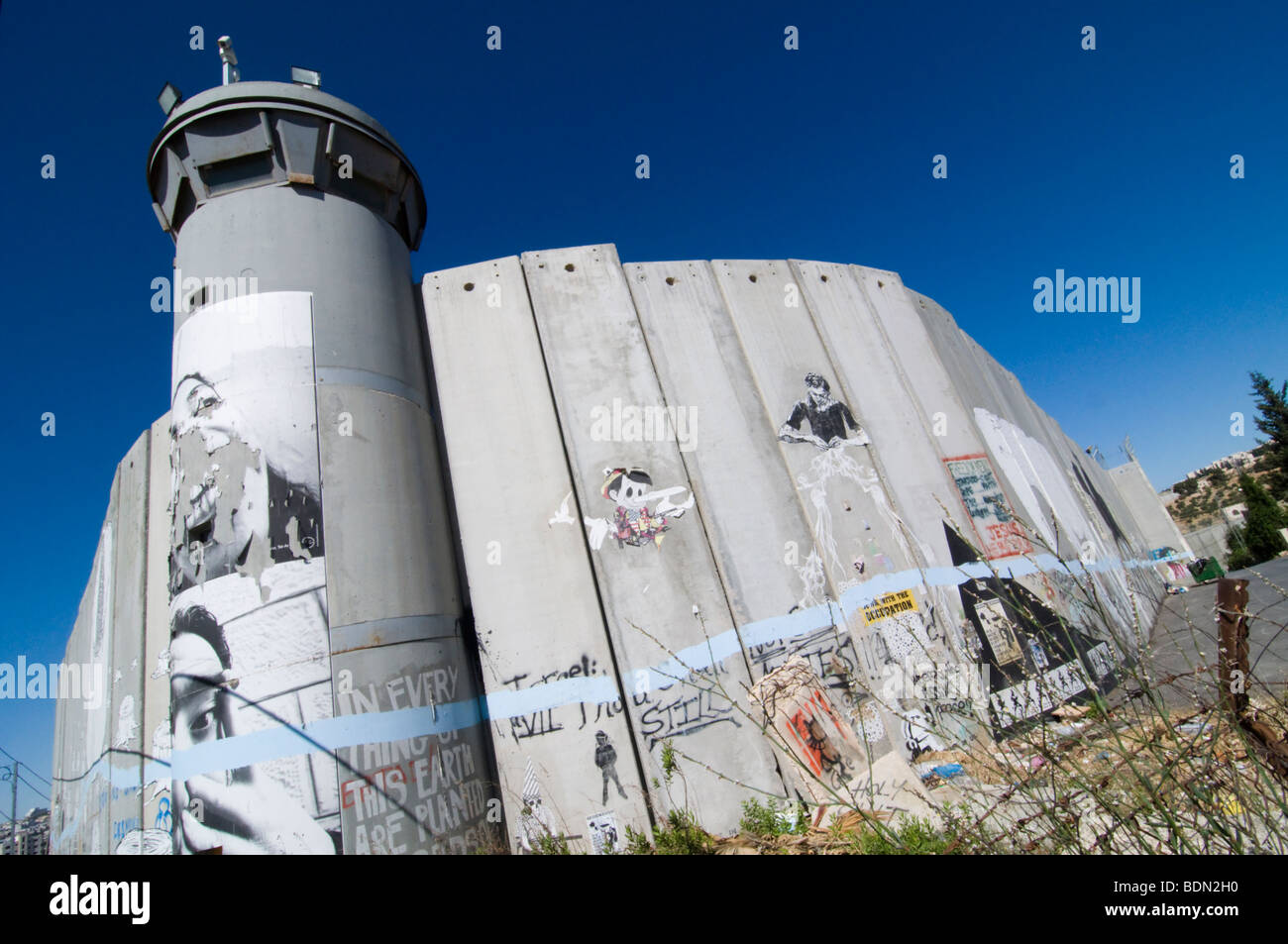 The Israeli separation wall juts into the Palestinian West Bank town of ...