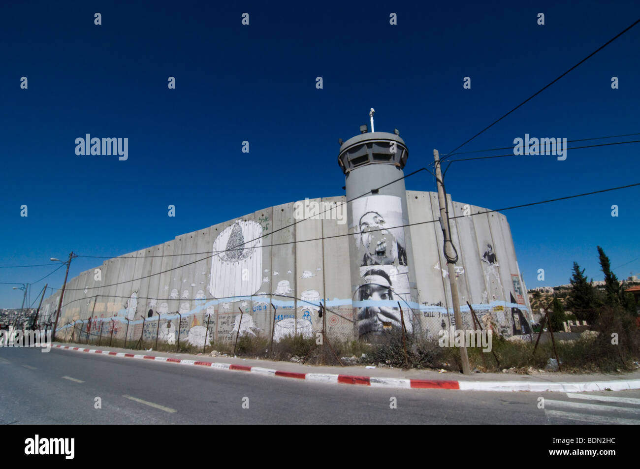 The Israeli separation wall juts into the Palestinian West Bank town of ...