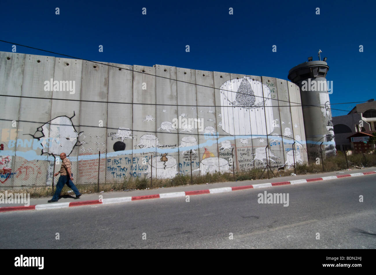 The Israeli separation wall juts into the Palestinian West Bank town of ...