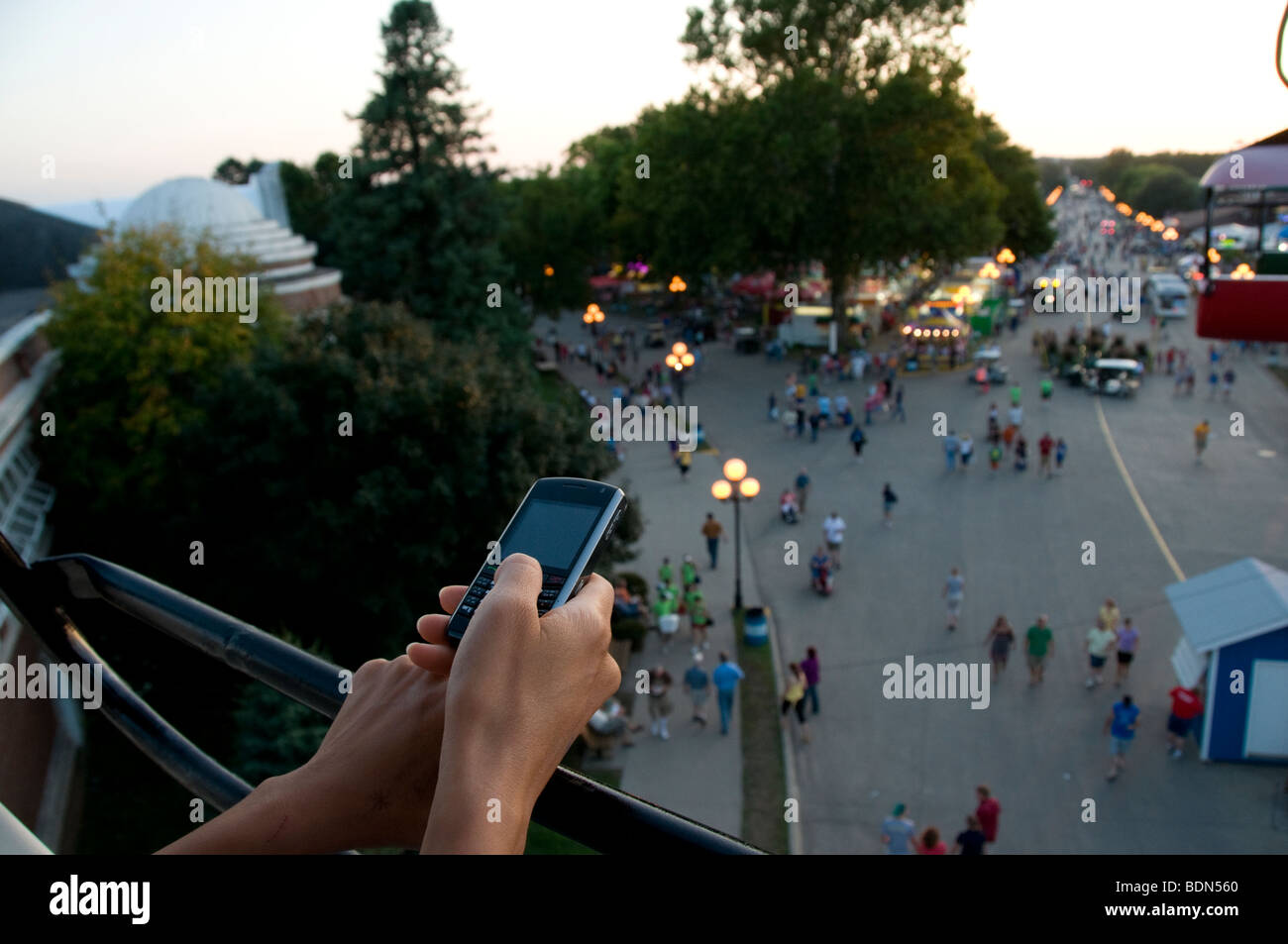 person using cellphone on sky tram at state fair Stock Photo - Alamy