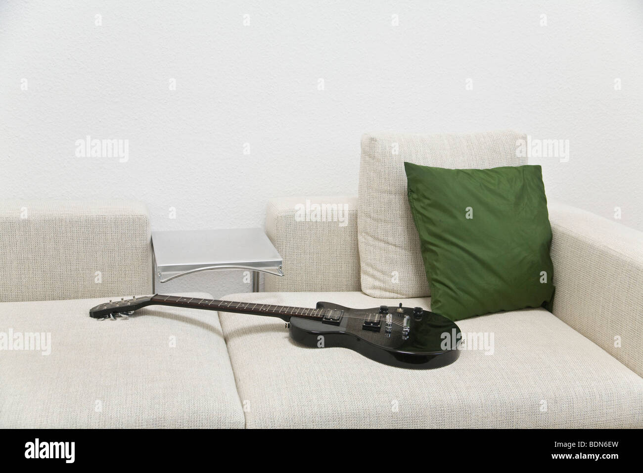 Sofa with electric guitar Stock Photo - Alamy