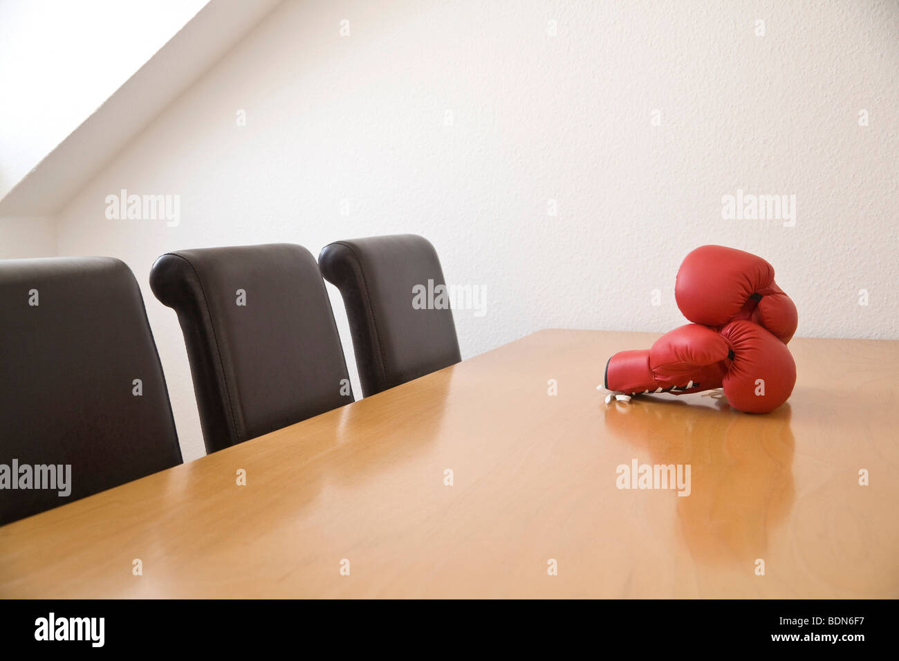 Table with chairs and boxing gloves Stock Photo - Alamy