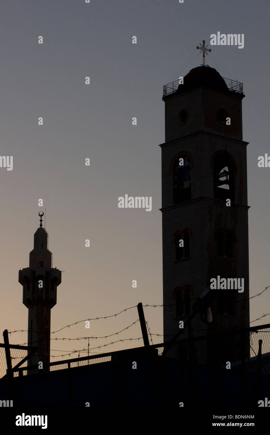 A minaret of the King Hussein Mosque and the steeple of the Greek ...