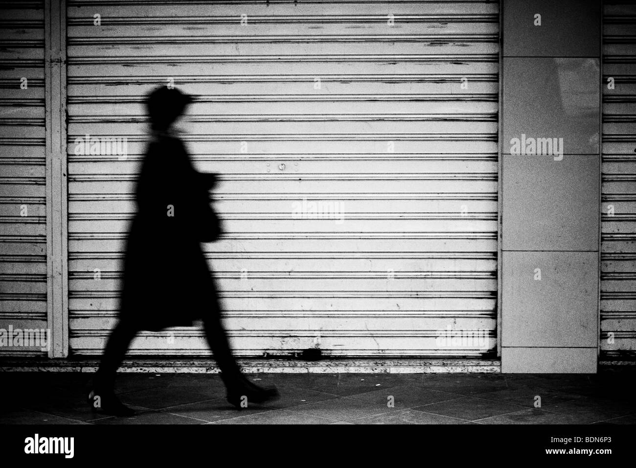 Woman in black walking hi-res stock photography and images - Alamy