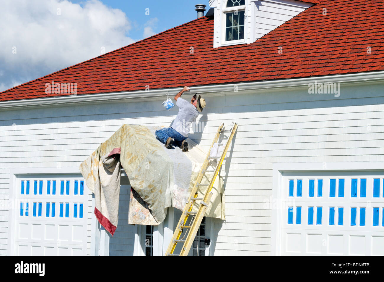 Man painting building Stock Photo - Alamy