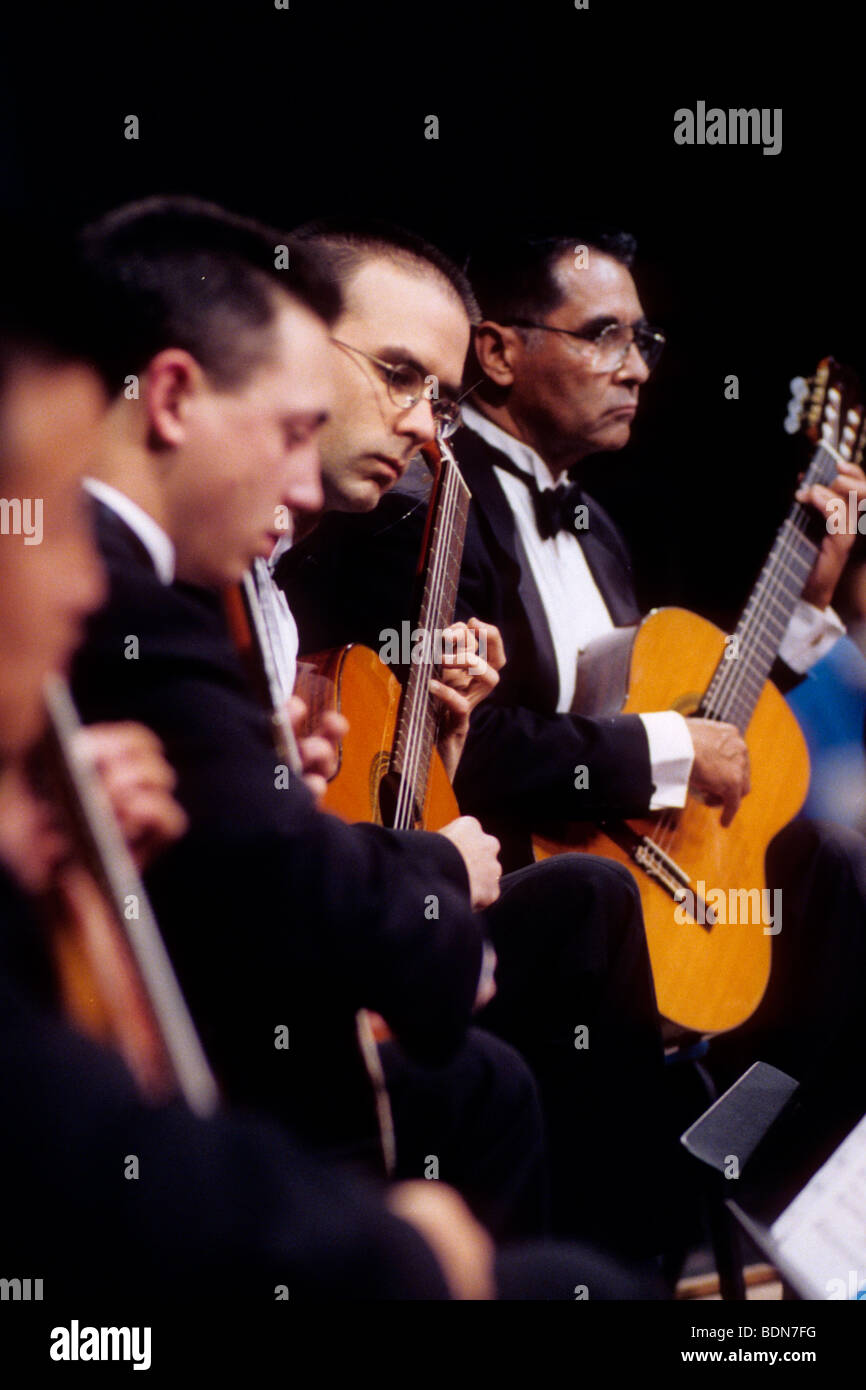 guitar ensemble orchestra Spanish instrument strum pick fingers serious ...