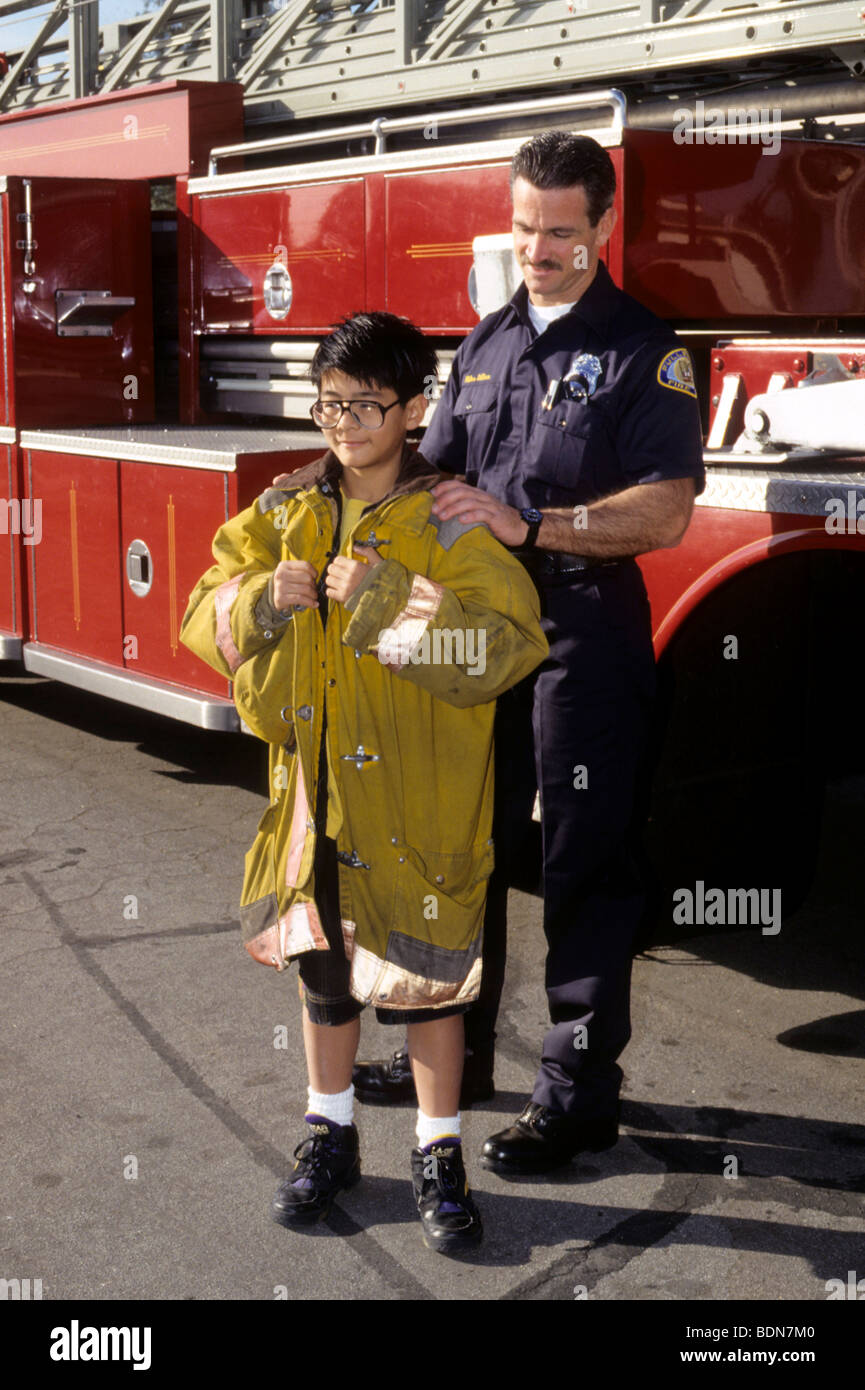 Korean-American male boy learn fire safety firetruck firefighter ...
