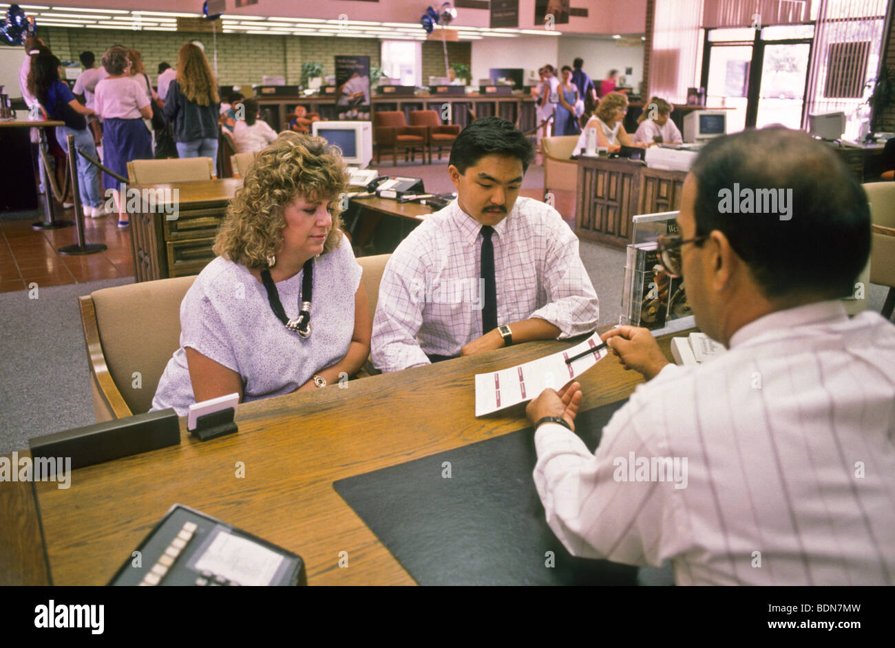 couple examine form application mortgage loan figure interest economy ...