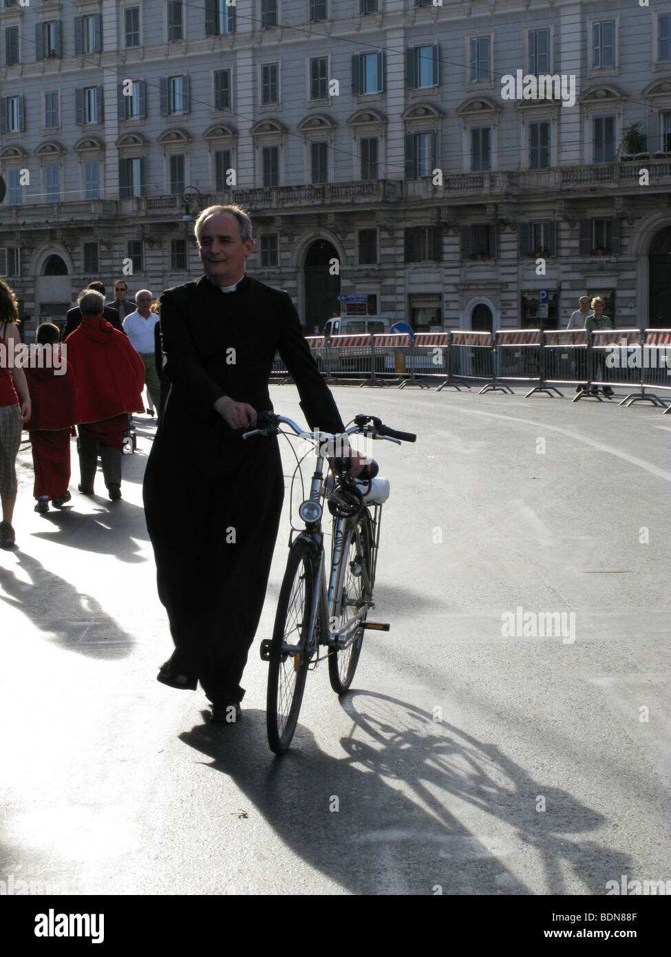 priest pushing bike in rome, italy Stock Photo - Alamy