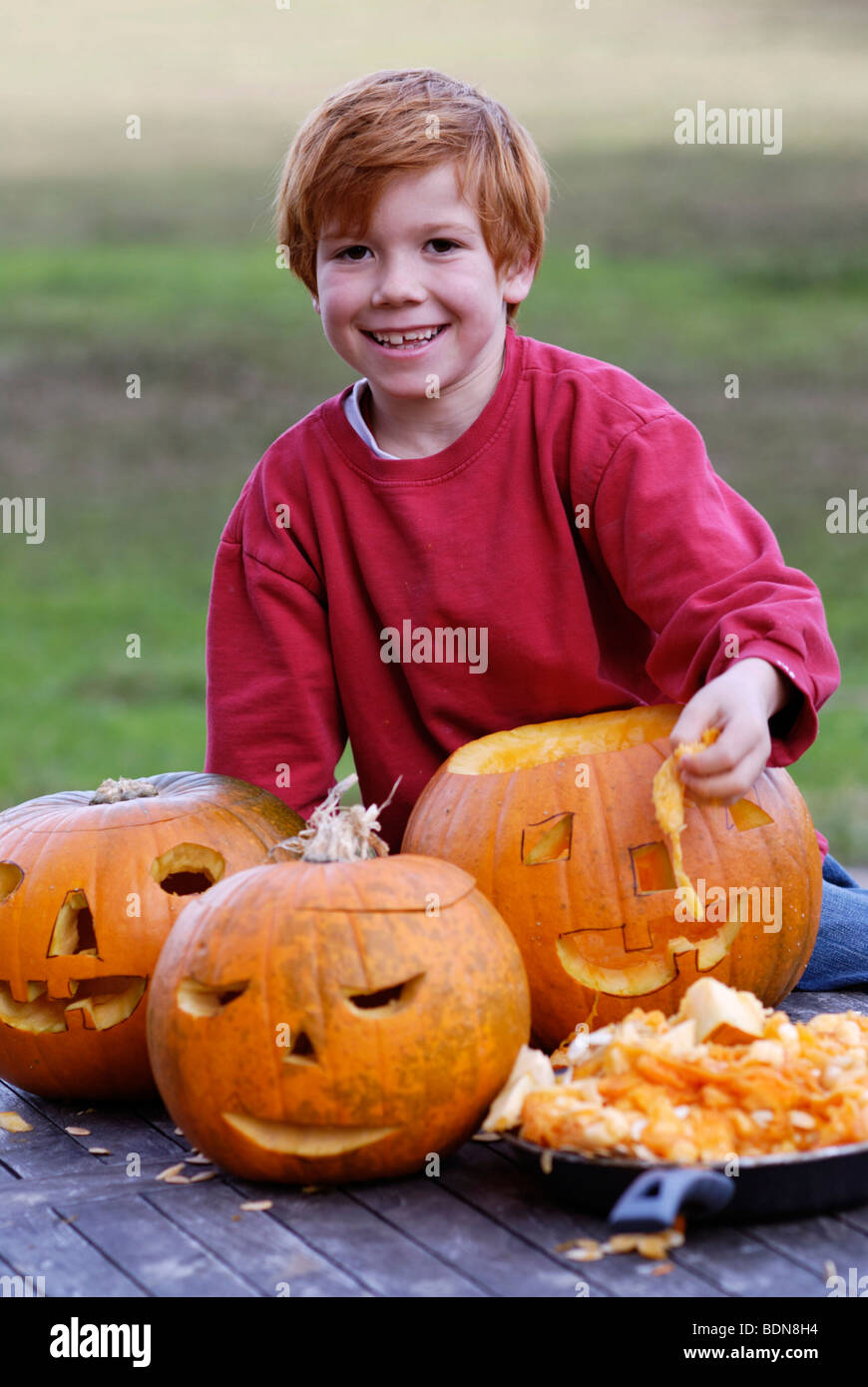 Boy carving a jack-o-lantern from a pumpkin for Halloween Stock Photo ...