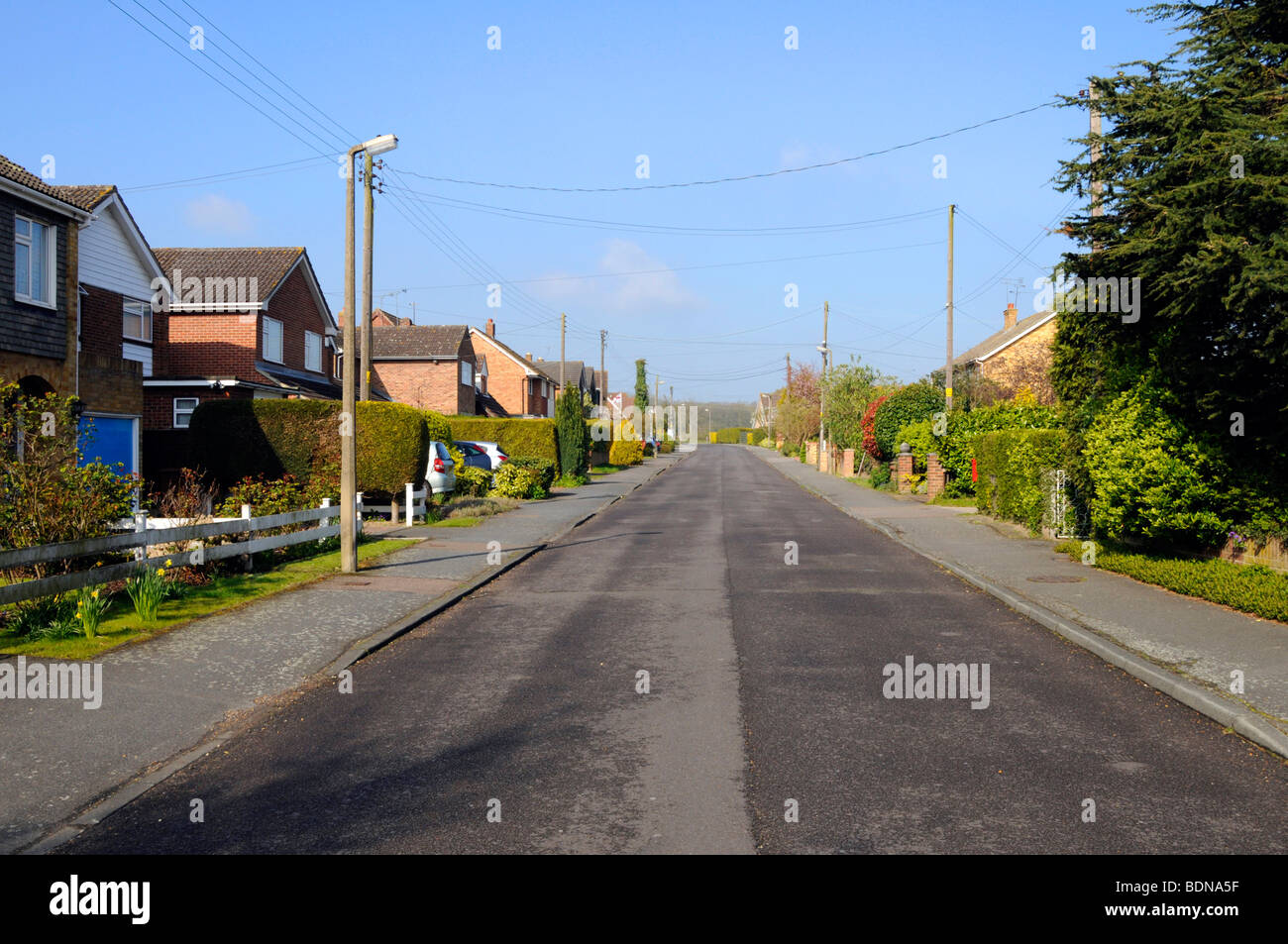 Straight village residential side turning road free of parked cars and ...
