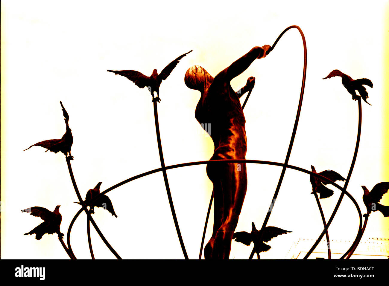 A sculpture with a human figure and birde Stock Photo - Alamy