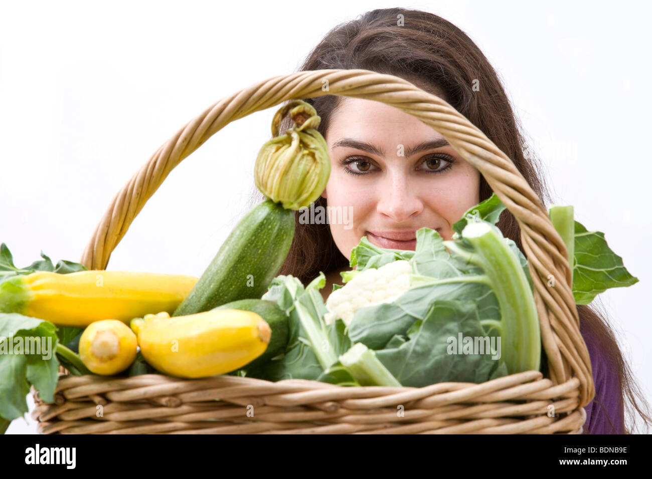 Girls looking through a vegetable basket Stock Photo - Alamy