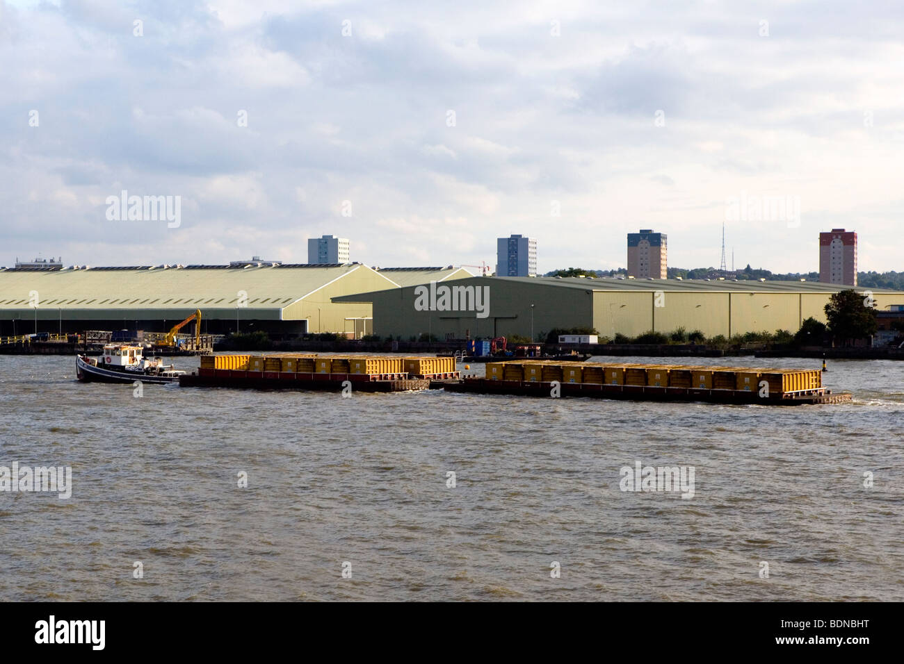 Boat pulling cargo containers down the Thames Stock Photo - Alamy