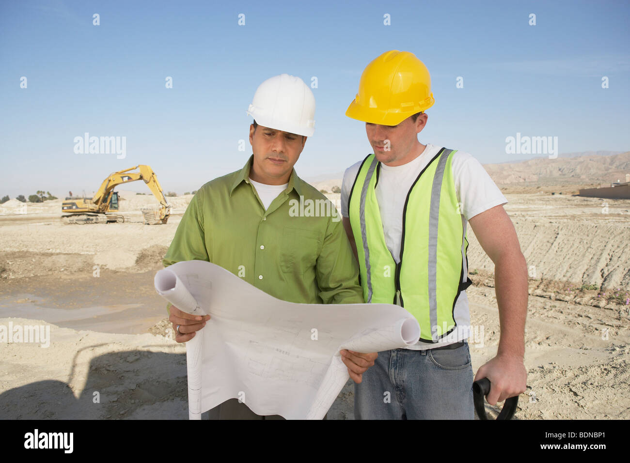 Construction Workers Reading Blueprints Stock Photo - Alamy
