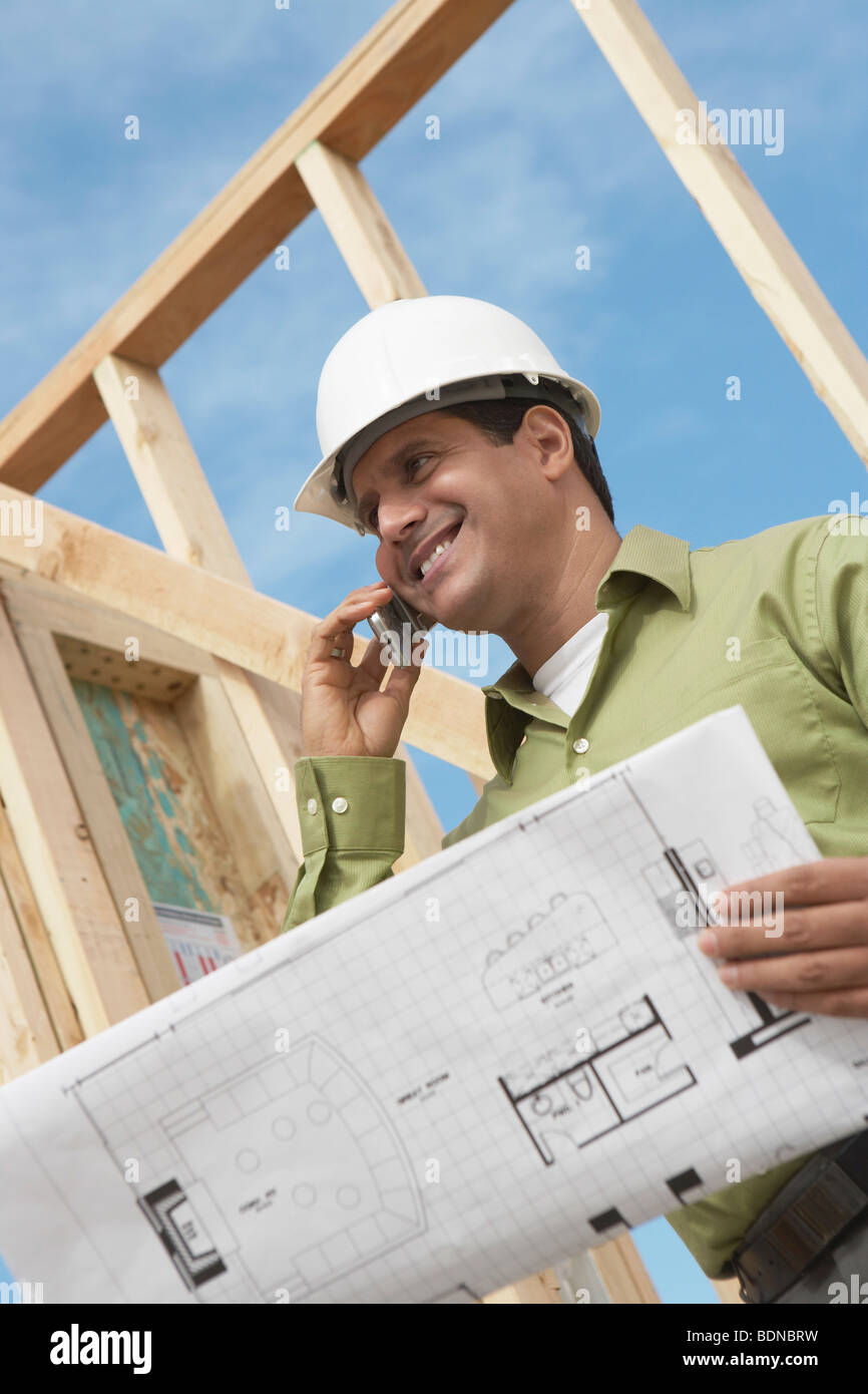 Construction Worker Using Cell Phone Stock Photo - Alamy