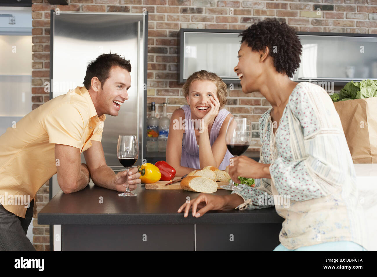 Friends in Kitchen Stock Photo - Alamy