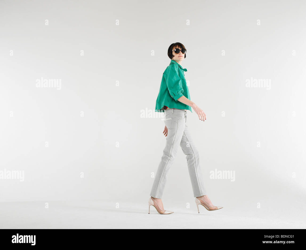 Young Stylish Woman Walking Stock Photo - Alamy