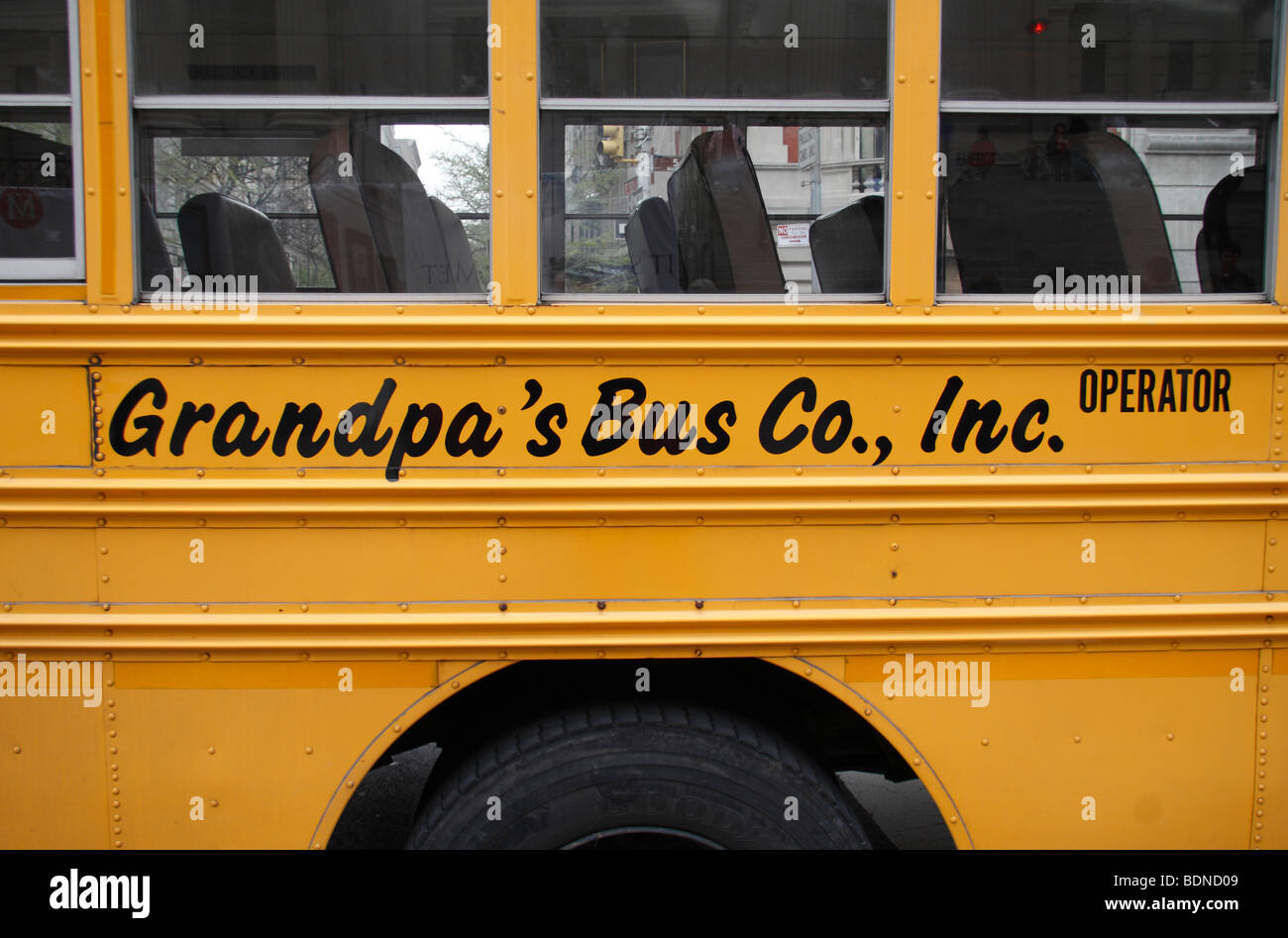Close detail of a yellow school bus operated by 'Grandpa's Bus Company ...