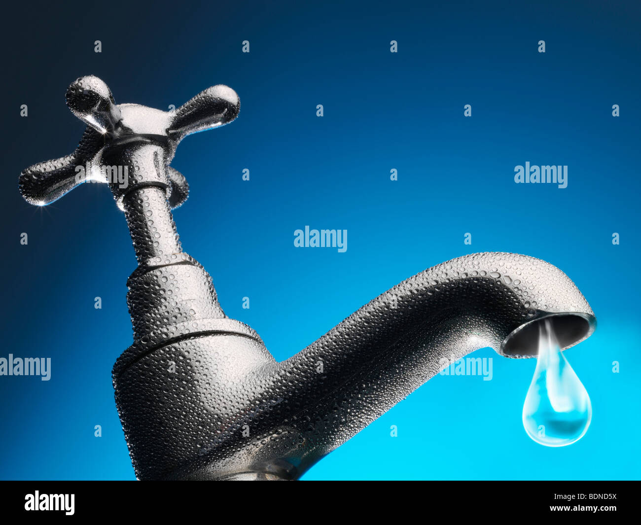 Drop of water trickling from tap, close-up (digital composite Stock ...