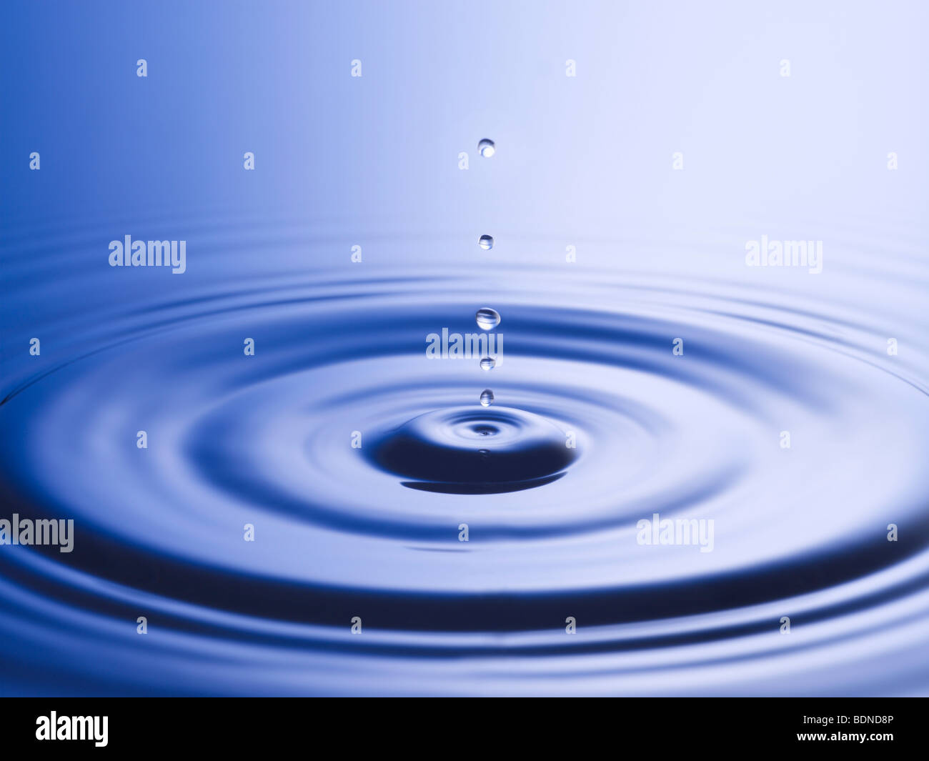 Drops hitting surface of water, close-up Stock Photo - Alamy