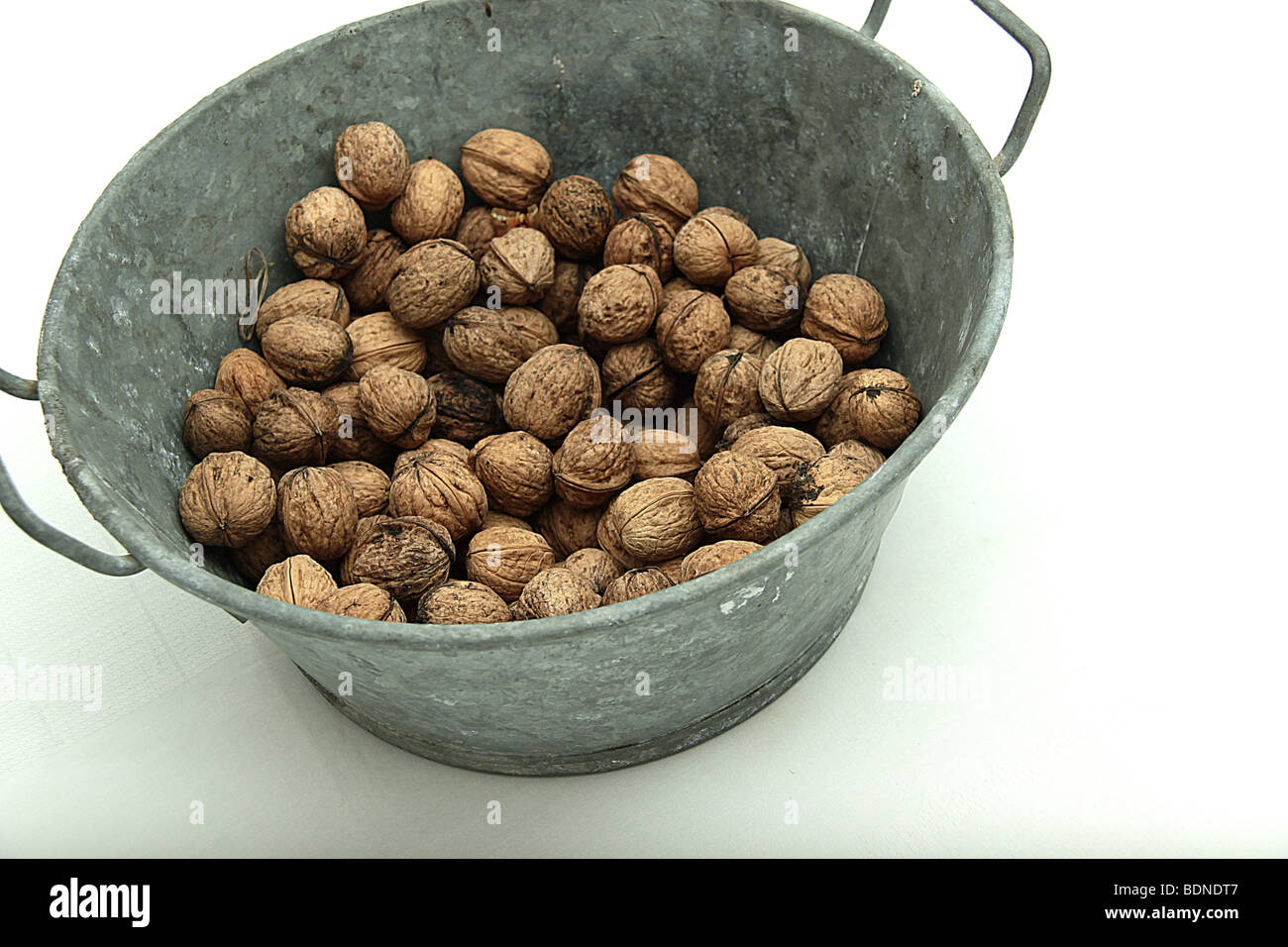 walnuts in an old bucket on isolated background Stock Photo - Alamy