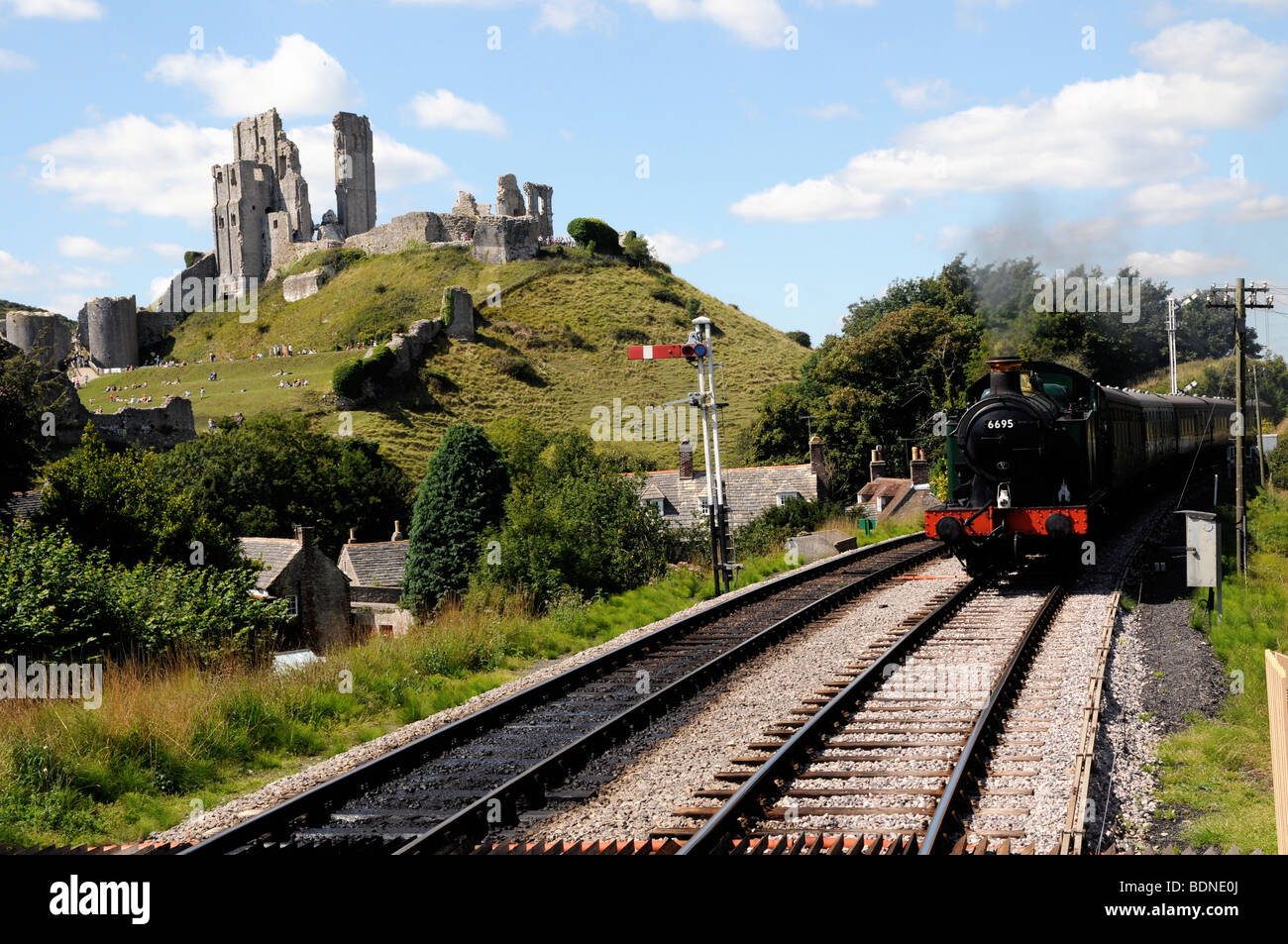 A steam train arrives at Corfe Castle railway station on its way to ...